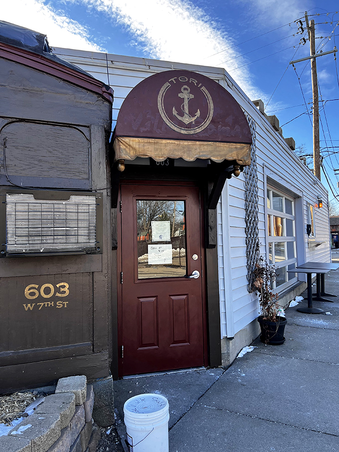 The unassuming entrance to Tori Ramen beckons curious diners with its anchor logo and promise of culinary treasures within.