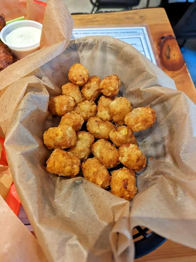These golden-fried cheese curds create that perfect cheese pull that makes everyone at nearby tables suddenly change their order.