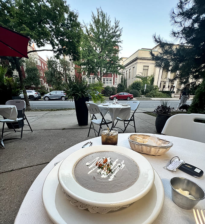 Outdoor seating under bright umbrellas offers the perfect spot to enjoy fine French cuisine while watching Oak Park life unfold on the street before you.