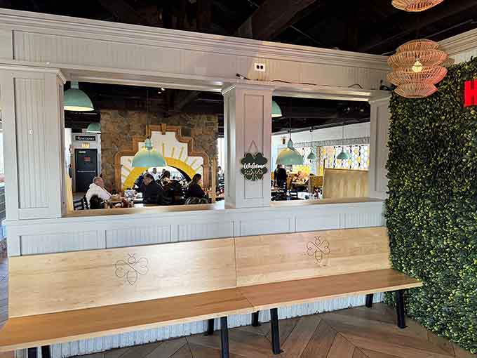 Waiting area with greenery wall and communal seating makes even the wait feel pleasant and inviting.