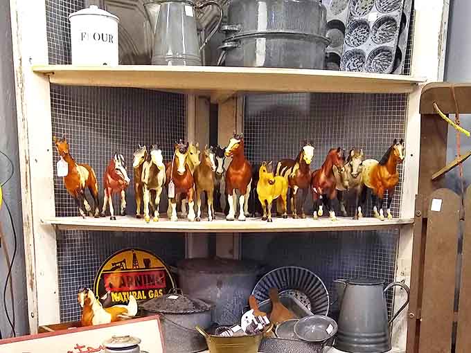 A herd of collectible horses stands at attention, waiting for a new owner to appreciate their detailed craftsmanship and nostalgic appeal.