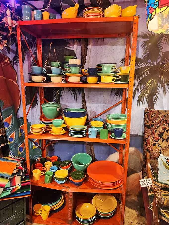 Colorful vintage dinnerware stacked on bright orange shelving proves that mid-century designers understood that meals taste better when served on beautiful, bold dishes.