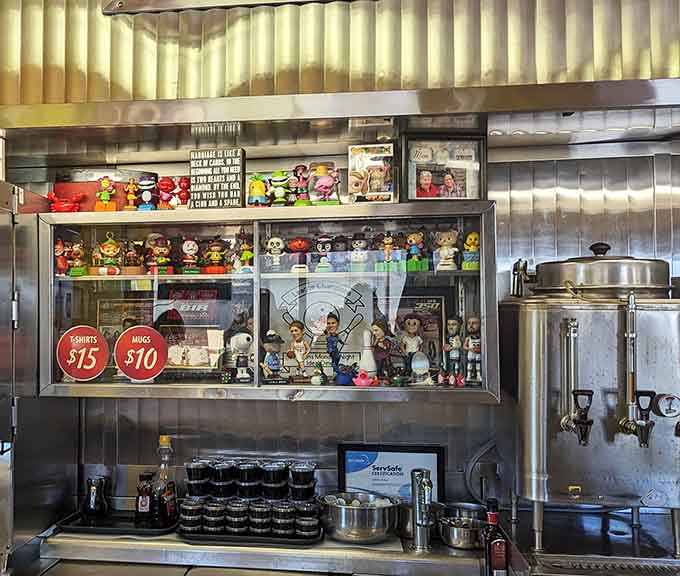 Behind the counter, colorful collectibles and coffee urns create a backdrop that's part museum, part working kitchen, all authentic diner charm.