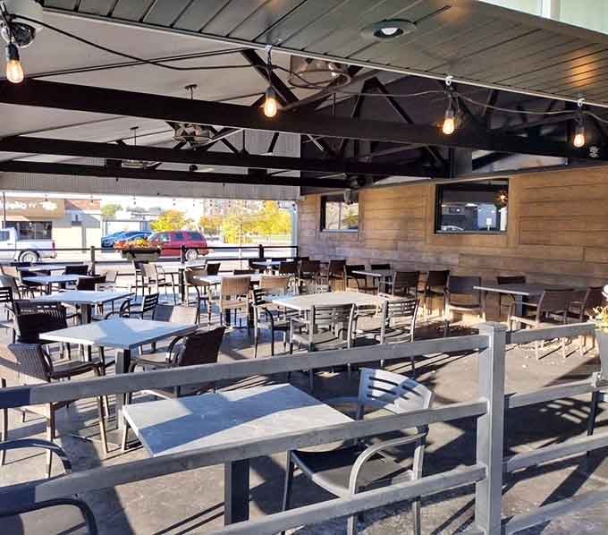 The spacious outdoor patio with picnic tables and string lights transforms warm evenings into special occasions worth lingering over for hours.
