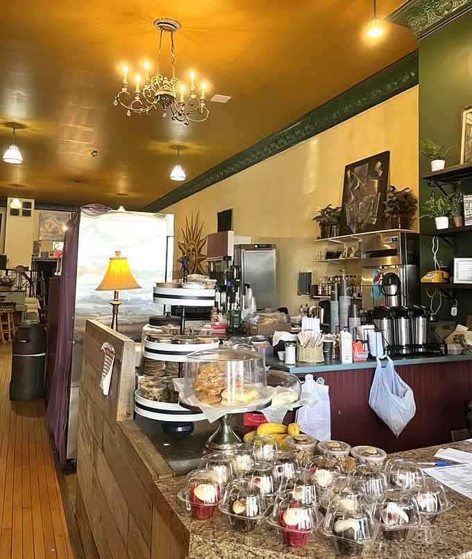 The counter area gleams with promise, displaying pastries under glass like edible art in a delicious museum.