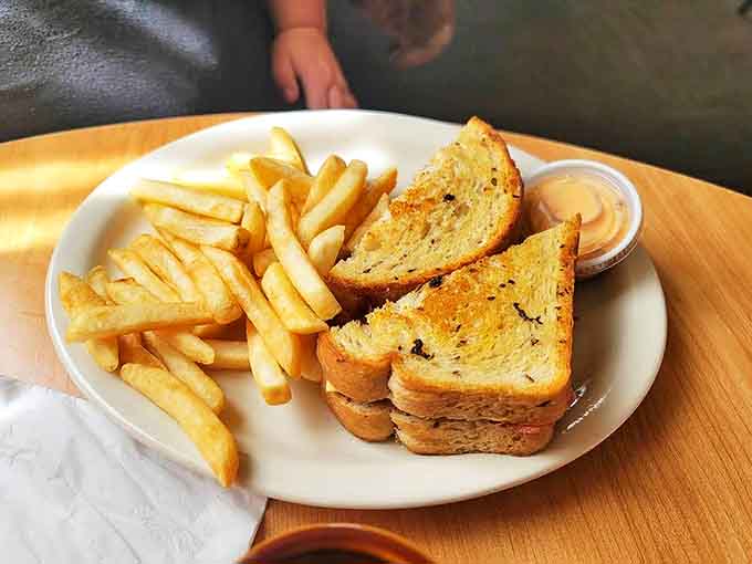 Patty Melt: The holy trinity of seasoned beef, melted cheese, and grilled bread, served with fries that deserve their own fan club.