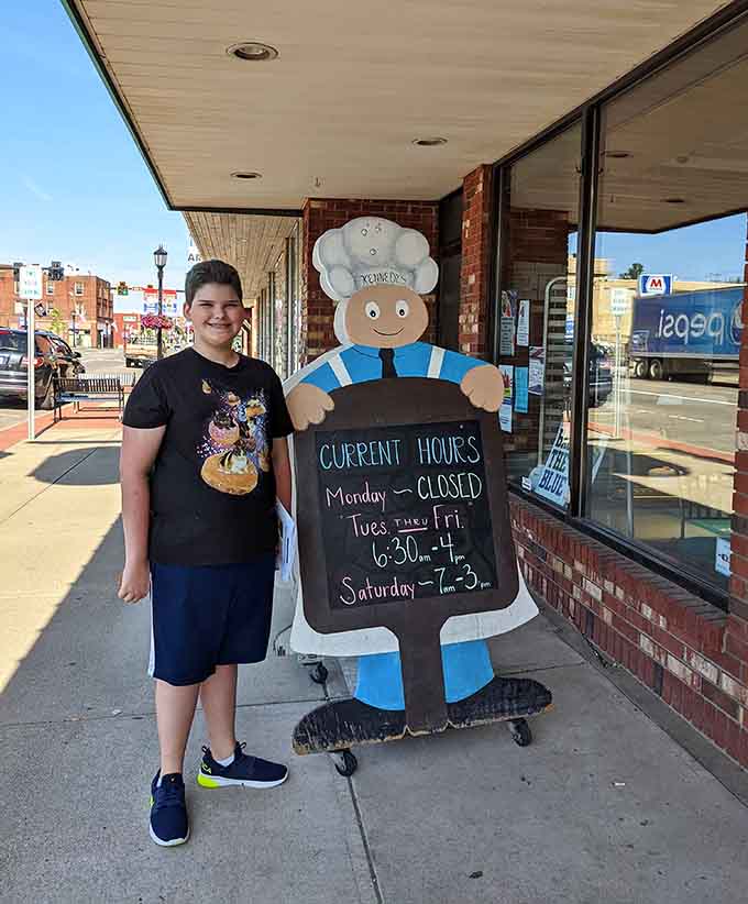 That cheerful baker cutout has been welcoming hungry visitors with the promise of carb-loaded joy for generations.