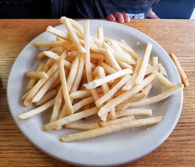 The crispy French fries serve as a perfect side option for those who want something different from the traditional rice and beans.