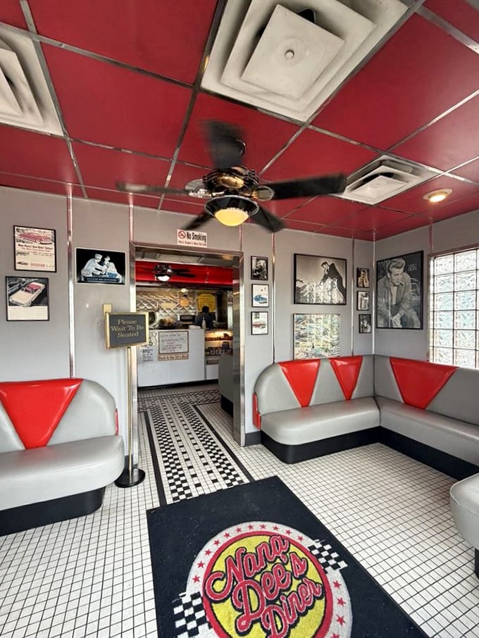 The waiting area's retro seating and checkerboard floor set the tone for the time-traveling experience that awaits hungry guests.