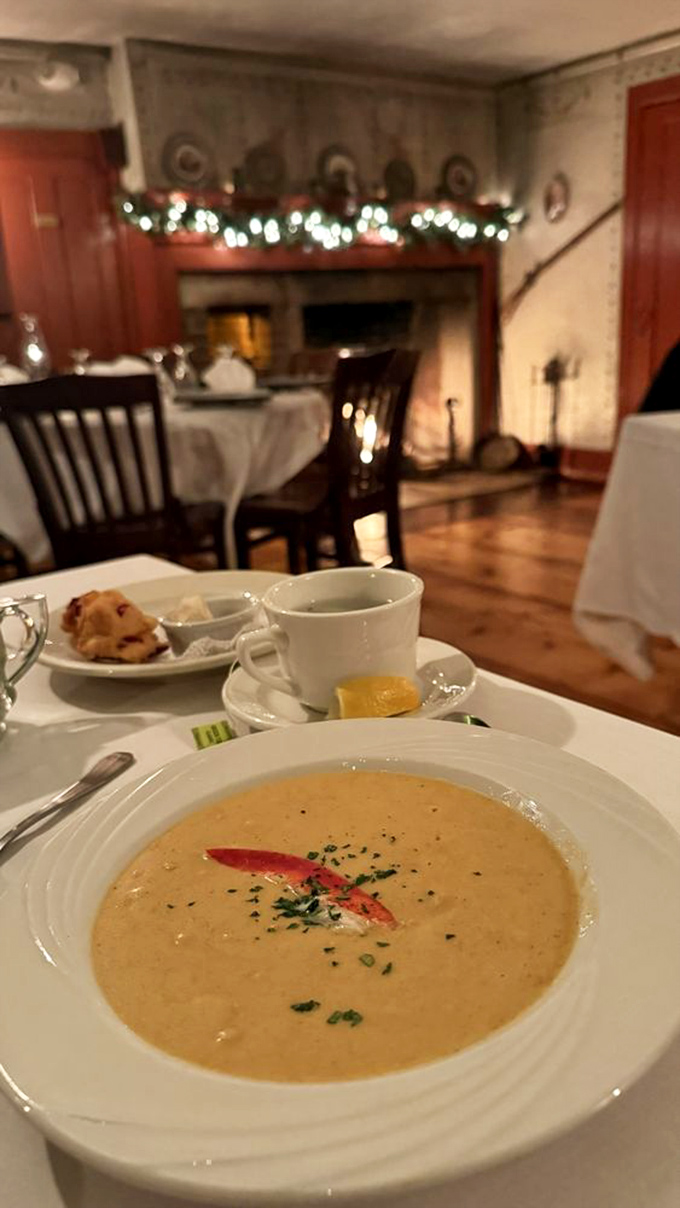 Velvety lobster bisque, garnished with a touch of fresh herbs and cream &ndash; a spoonful of New England coastal tradition in the Vermont mountains.