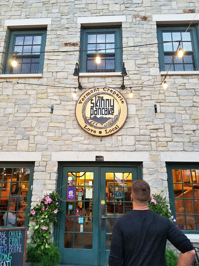 The circular emblem promising "Vermont Creperie" and "Love Local" isn't just branding &ndash; it's a mission statement hanging proudly on historic stone walls.
