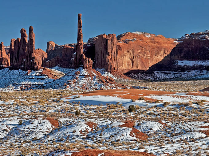 Winter transforms Monument Valley into something even more surreal, where snow-dusted red rocks create a color combination you didn't know you needed.