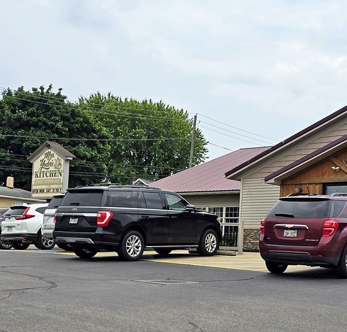 A parking lot where SUVs and minivans gather like pilgrims at a culinary shrine.