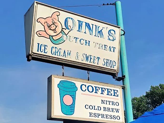 The cheerful pig mascot grins down from his signage perch, a porcine promise that life-changing frozen yogurt awaits just beyond those doors.