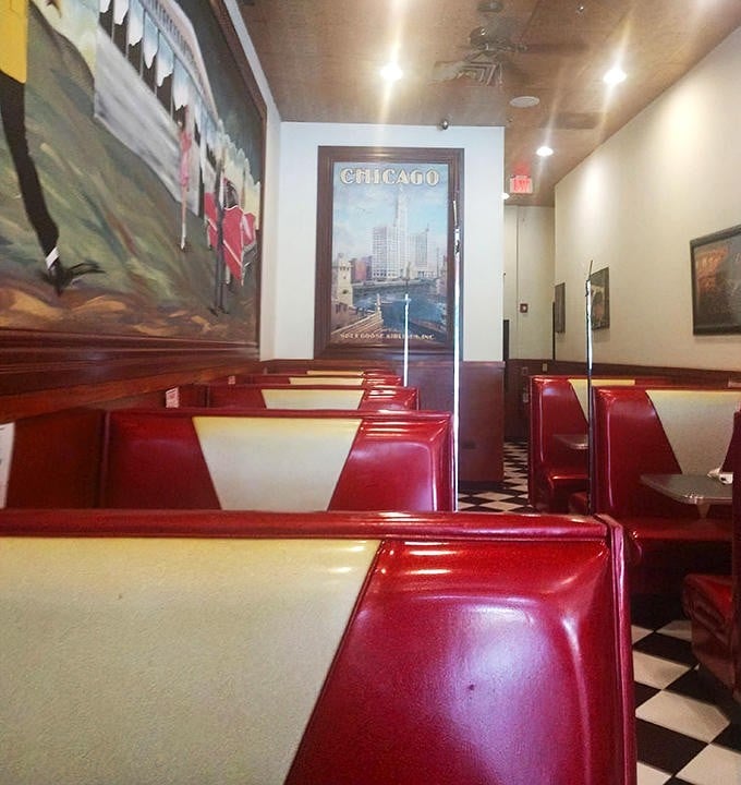 Another view of the dining room shows the vintage Chicago poster and classic diner setup that makes every visit feel like a trip back in time.
