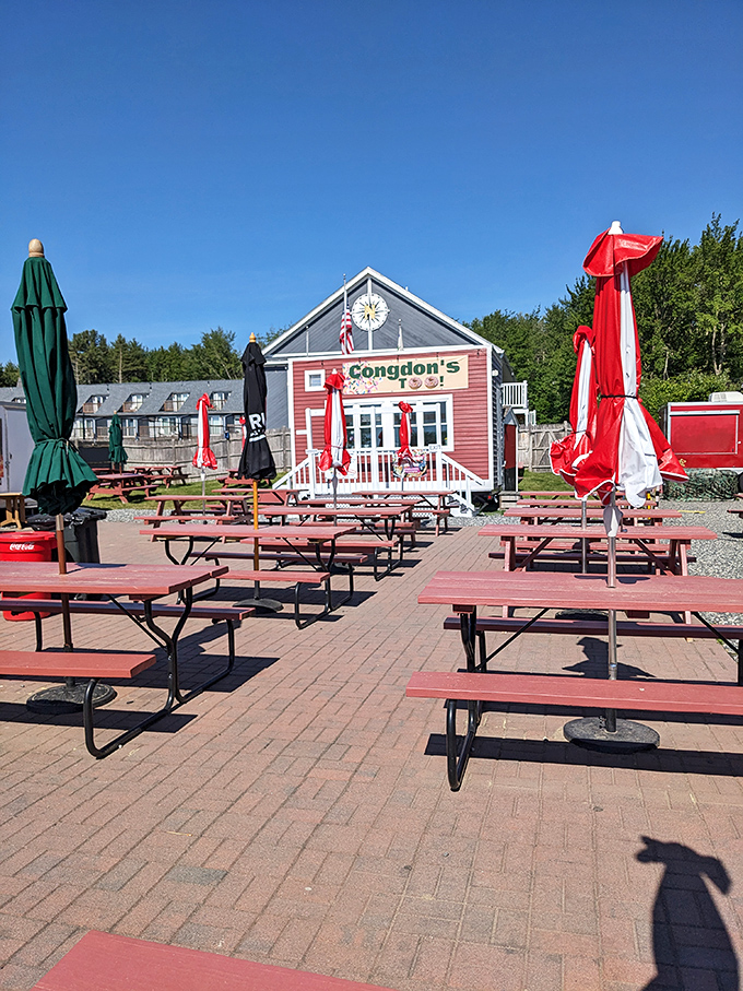 The outdoor seating area awaits with picnic tables and umbrellas &ndash; a community gathering spot where strangers become friends over shared sugar highs.