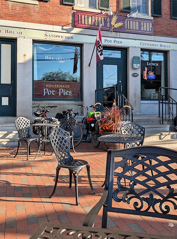 The outdoor seating area invites lingering conversations over coffee and pastries, where wrought iron tables catch morning sunlight and passing smiles.