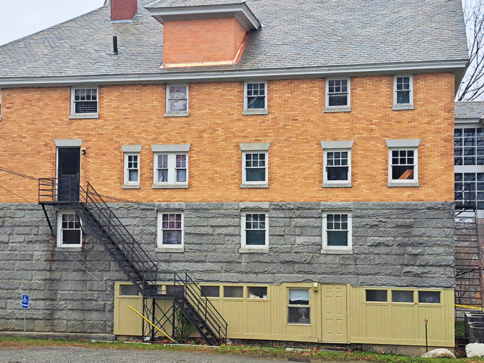 The building's impressive stone foundation and brick upper stories create a striking profile against the Vermont/Quebec sky, architecture that refuses to be confined.