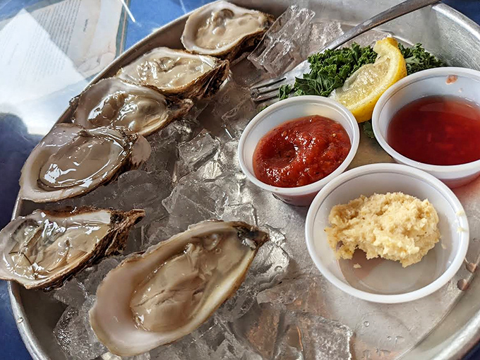 Fresh oysters glisten on ice, awaiting their fate with mignonette, cocktail sauce, and lemon standing by as willing accomplices.