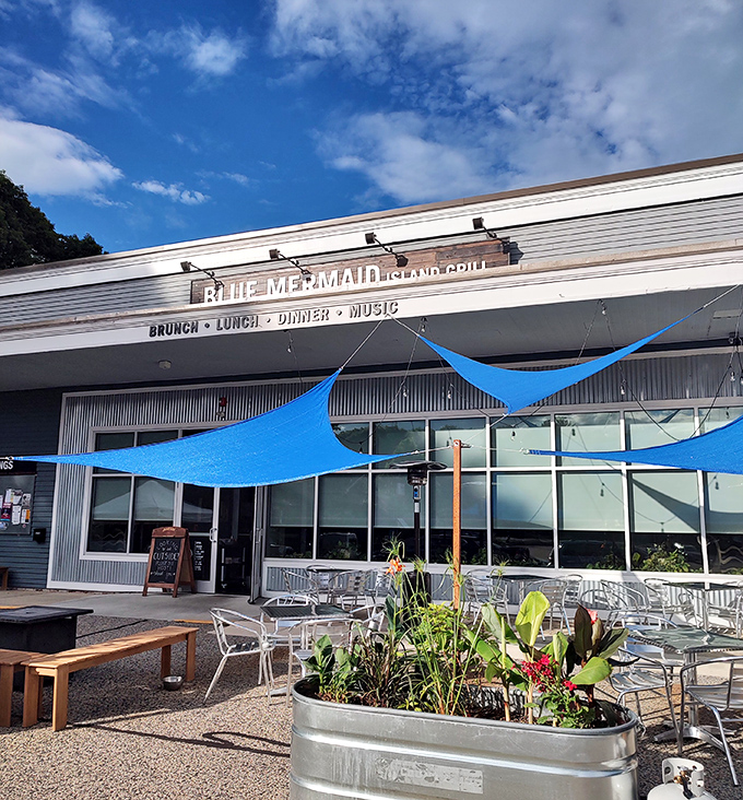 The outdoor patio offers fresh air dining under blue sail shades &ndash; Maine sunshine with a side of island vibes.