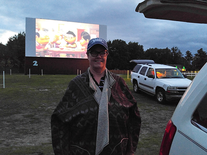 Bundled against the evening chill, drive-in patrons create their own comfort zones, proving movie magic doesn't require theater seats.