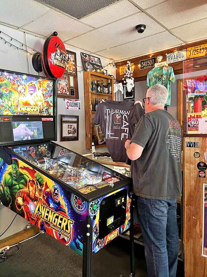 The Avengers pinball machine stands ready for those who somehow have coordination left after wrestling with a burger taller than most children's heads.