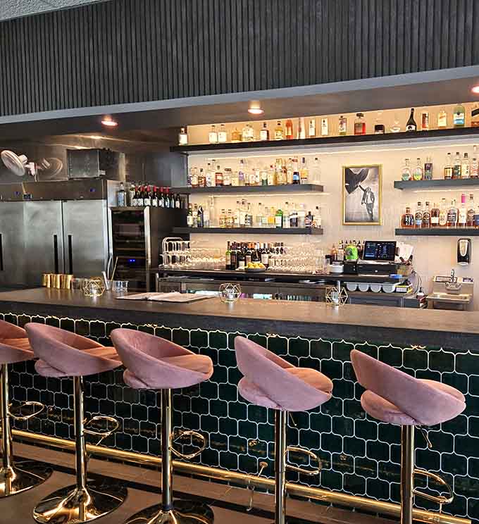 The bar's pink velvet stools and hexagonal tile make ordering a drink feel like a special occasion every time.