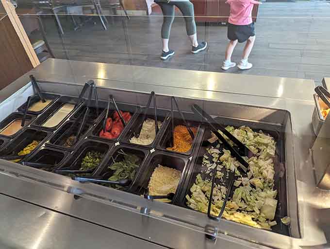The salad bar offers fresh toppings and vegetables for those brief moments when you pretend to care about nutrition.
