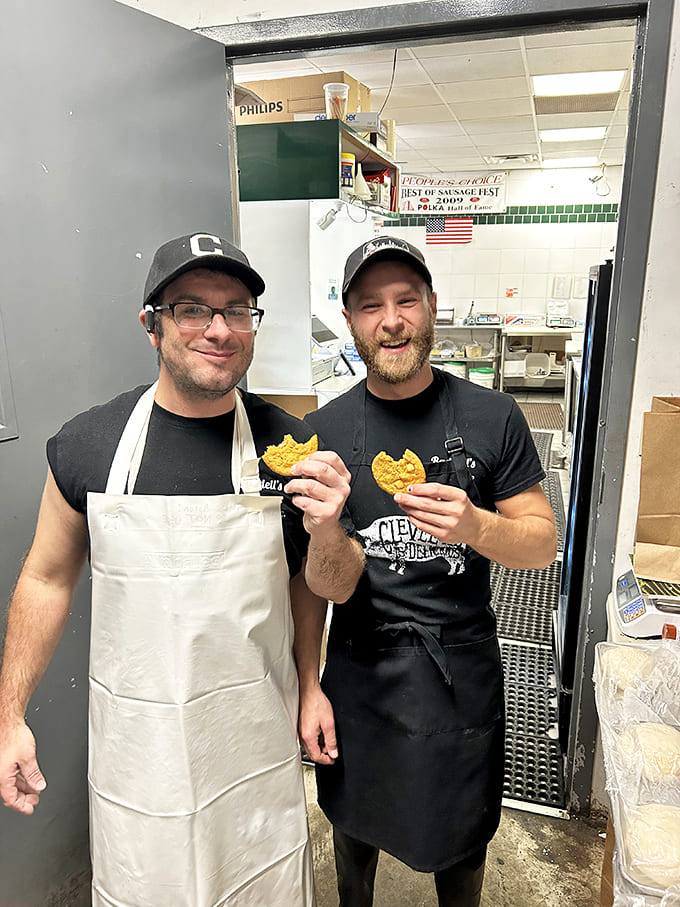 The sausage maestros behind the magic, proudly displaying their handiwork with the satisfied grins of true artisans.