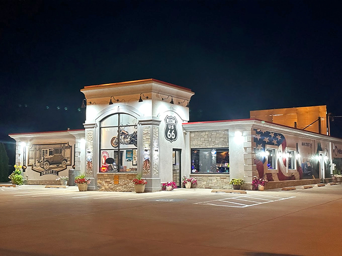 After dark, this Route 66 beacon glows like a lighthouse for hungry travelers, promising warm welcomes and hot meals.