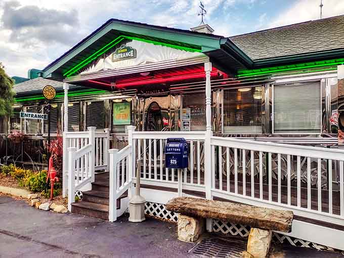 The entrance welcomes you with a white railing and the promise of comfort food just beyond those doors.