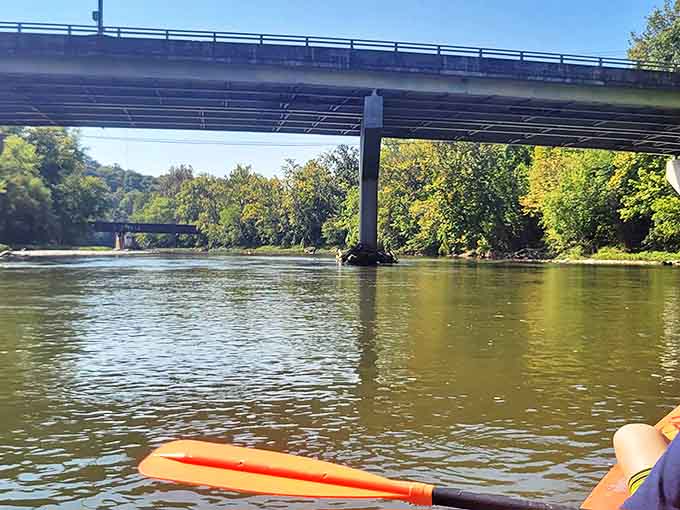 Paddling beneath modern bridges while heading toward a medieval castle creates the kind of time-travel confusion that makes this trip so memorable.