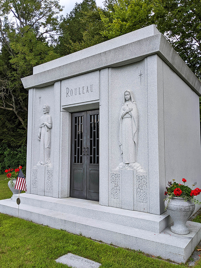 The Rouleau family mausoleum stands as an architectural gem, its doorway flanked by figures that welcome visitors with silent dignity.