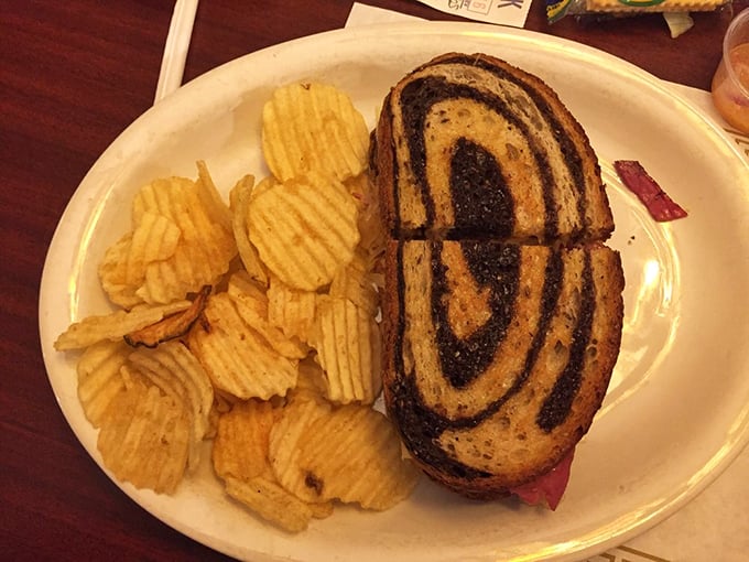 The Reuben: where corned beef meets sauerkraut in a delicious dance. Those chips? They're not just sidekicks, they're flavor wingmen.