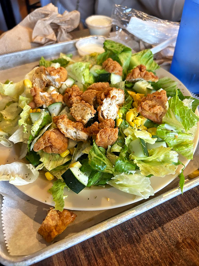 Even the salad gets the royal treatment here. It's like a garden party, but with more fried chicken and less small talk.