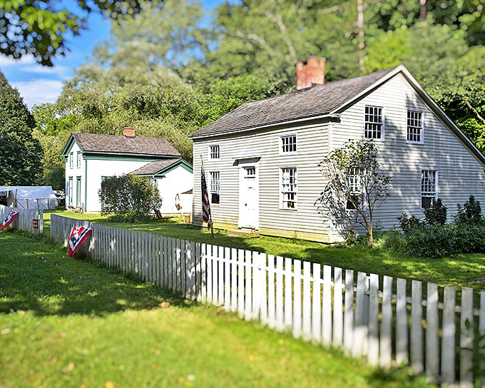 White picket fences frame these historic homes like a Norman Rockwell painting come to life, showcasing early American architecture at its most charming.