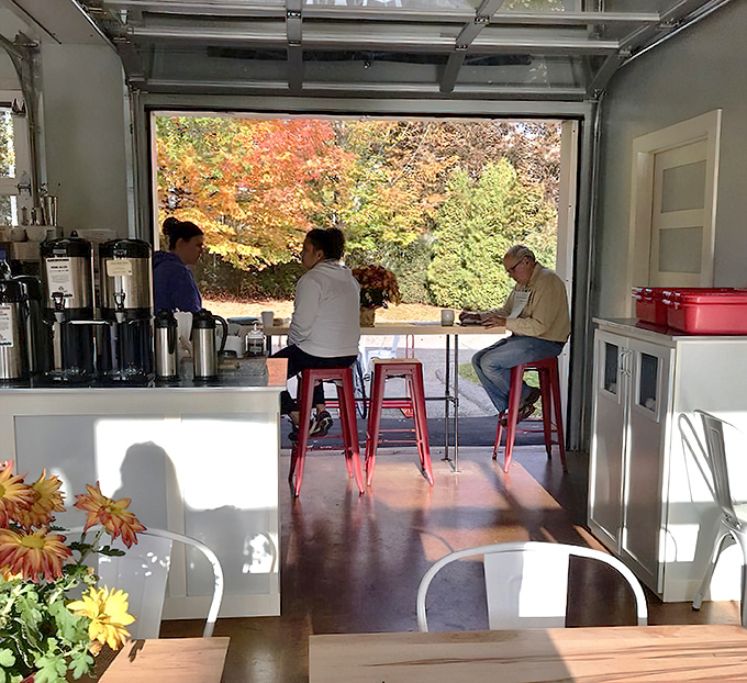 The seating area offers a front-row view of Maine's seasonal beauty, making every coffee break feel like a mini-vacation.