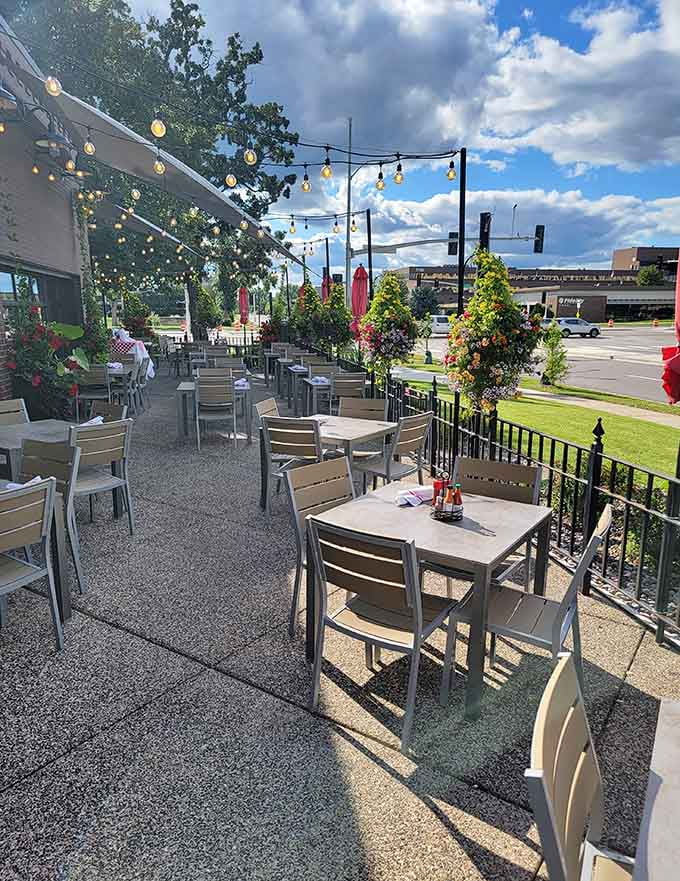 String lights and flowering planters transform this outdoor patio into a summer evening destination worth savoring slowly.