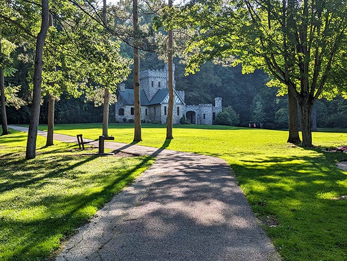 Tree-lined paths lead visitors through dappled sunlight toward stone towers, because apparently Ohio does fairy tale settings just fine, thank you.