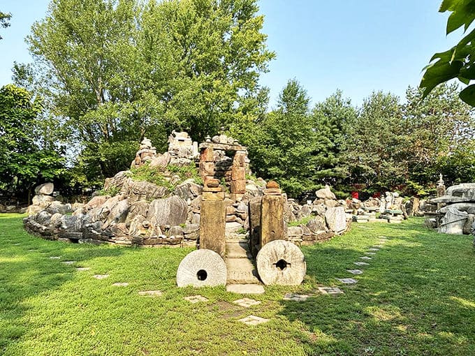 Millstones and carefully stacked rocks create natural gathering spaces throughout the garden, inviting visitors to pause and connect.