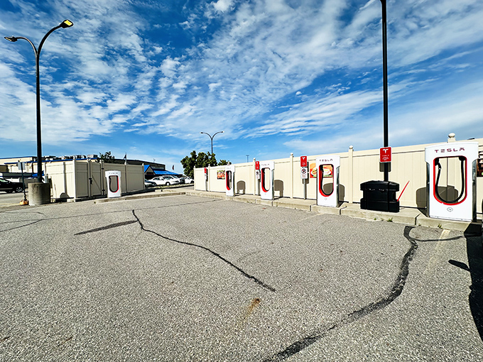Modern meets traditional as Tesla Superchargers wait outside, powering up vehicles while owners power up inside.