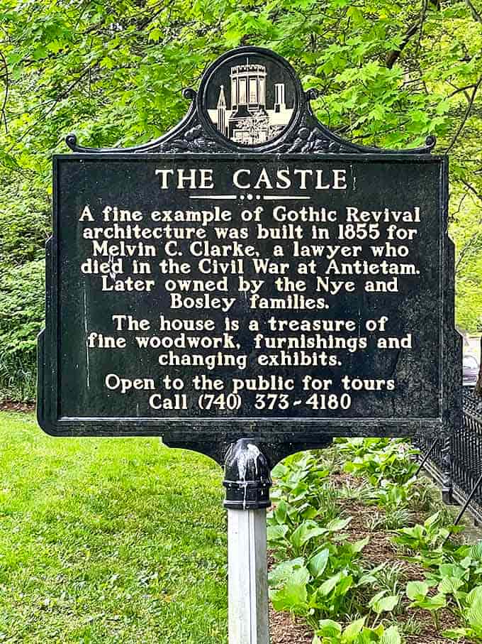 The historical marker reveals The Castle's storied past, from its creation by Melvin Clarke to its current role as a cherished community treasure.