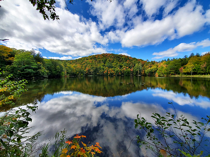 The Pogue offers perfect reflections of surrounding foliage &ndash; nature's mirror showing off Vermont's autumn splendor from every possible angle.