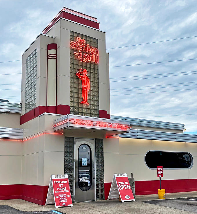 Entrance: The neon sign glows like a lighthouse for hungry souls, promising salvation in the form of comfort food classics.