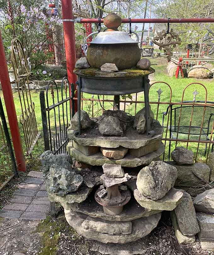 This tiered fountain of stones and metal demonstrates that water features are overrated when you can create visual flow with pure geological determination instead.