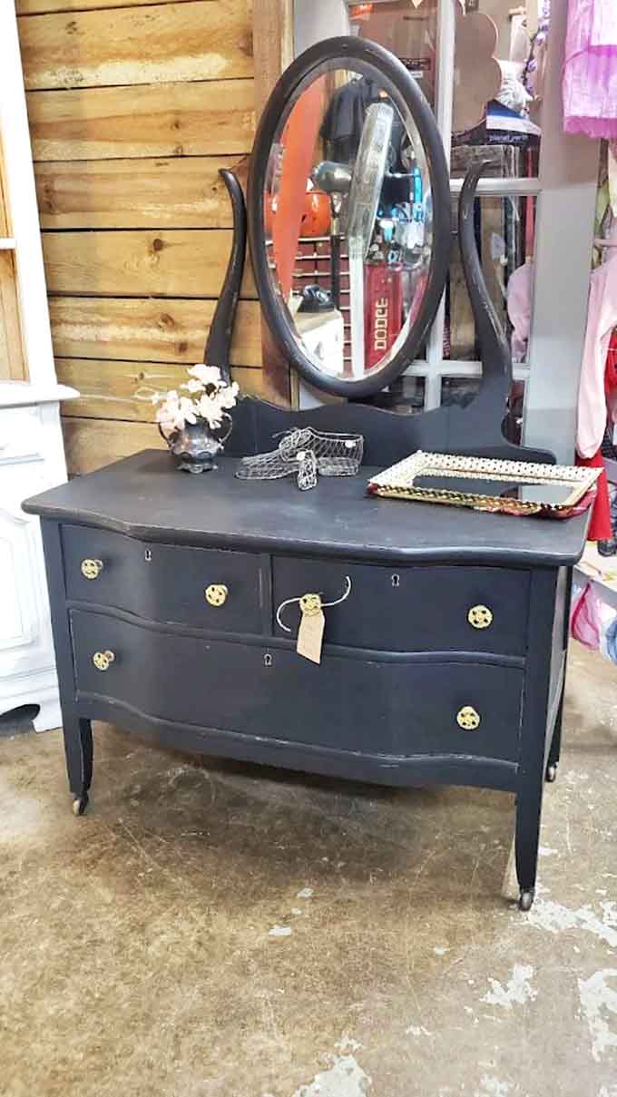 This refinished dresser with its oval mirror represents the kind of bedroom furniture that made getting ready in the morning feel elegant.