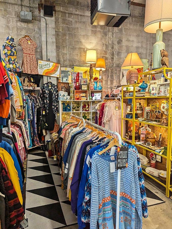 Vintage clothing hangs like colorful ghosts of parties past, each garment whispering stories of first dates and special occasions waiting to be relived.