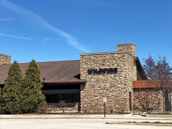 Wildfire stands proud against blue skies, its stone exterior a fortress protecting culinary treasures waiting to be discovered inside.