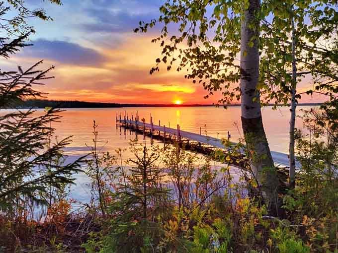 Sunsets over Bass Lake don't just paint the sky, they set the water on fire with colors that cameras can barely capture and memories definitely can't.