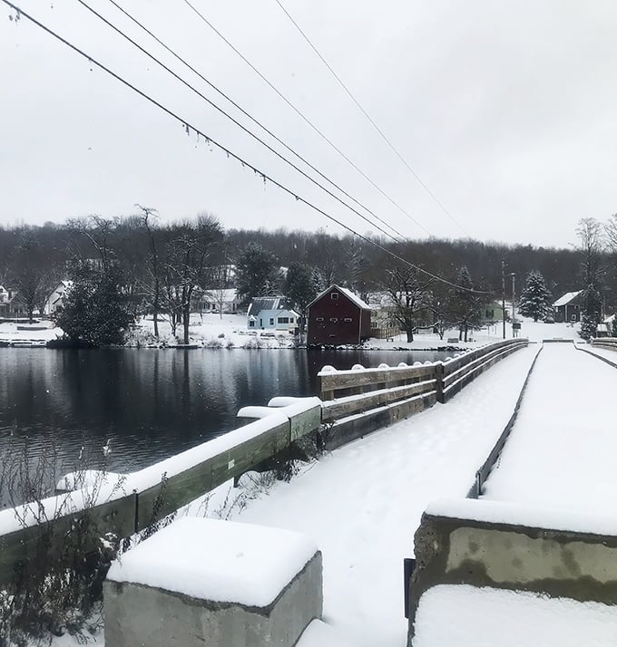 Winter transforms the crossing into a snow-dusted wonderland, where the bridge connects not just shores but seasons.